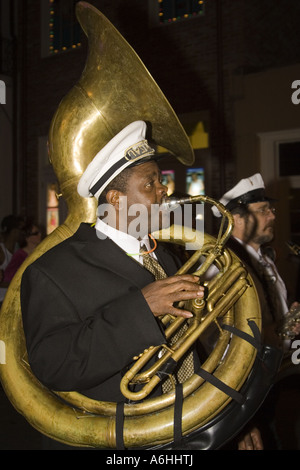 A second line brass jazz band parades down Bourbon Street in the French ...