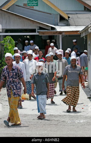 Muslim men leave a mosque after Friday prayer ahead of holy month ...