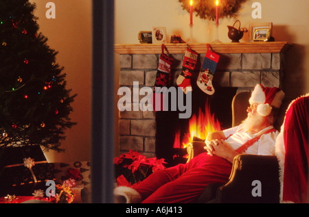 Santa Asleep by the Fireplace Stock Photo - Alamy