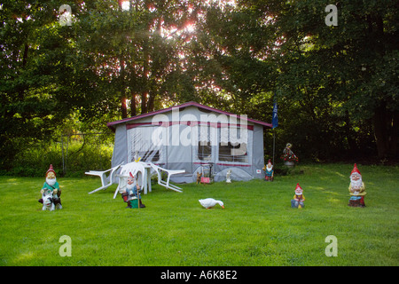 caravan on a campground with garden gnomes in front Stock Photo - Alamy
