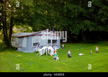 caravan on a campground with garden gnomes in front Stock Photo - Alamy