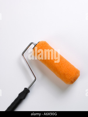 A paint roller on an orange surface with color samples Stock Photo - Alamy