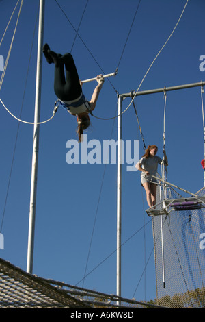 Woman trapeze artist flies above the net Stock Photo - Alamy