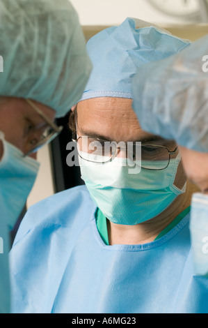 Doctors and nurses gather around operating table during surgery Stock ...