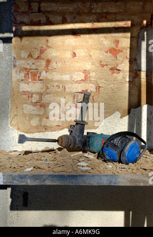 Hearing protectors with builder's tools on table near light wall Stock ...