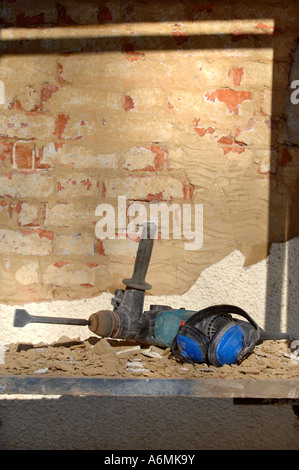 Hearing protectors with builder's tools on table near light wall Stock ...