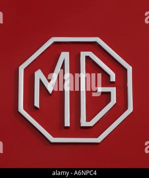MG logo on red car - close-up view. Octagonal british car emblem on the ...