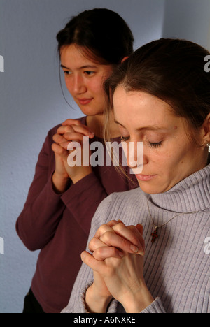 Two girls in fervent prayer Stock Photo - Alamy