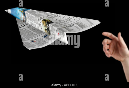 A person throwing a Paper airplane made from newspaper Stock Photo - Alamy