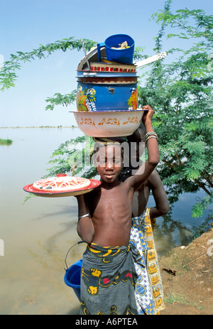 Young girls from the Bozo tribe washing dishes in the River Niger at ...