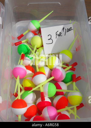 Bright colorful fishing bobber floats in water surface of lake, river ...