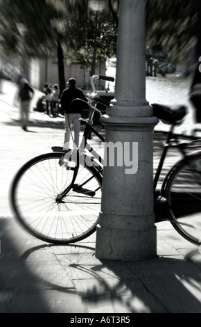 bicycle leaning against post Amsterdam Stock Photo - Alamy