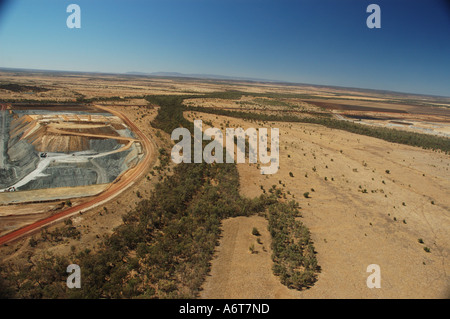 Outback river runs past open cut coal mine Central Queensland coal ...