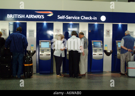 People use British Airways self service check in machines at Heathrow ...