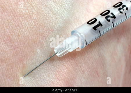 Hypodermic syringe needle entering arm Stock Photo - Alamy