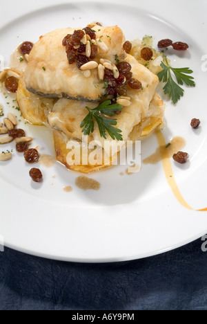 Cod with raisins and pine kernels Stock Photo - Alamy