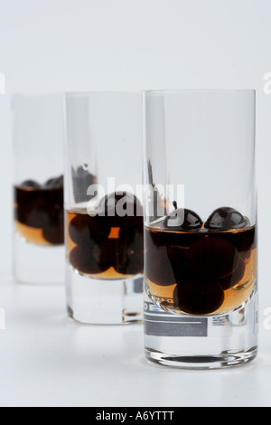 Sloe gin shots with sloe berries inside Stock Photo - Alamy