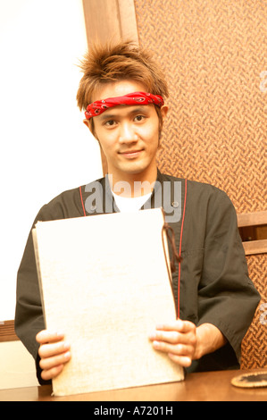 Young man holding menu in outdoors cafe Stock Photo - Alamy