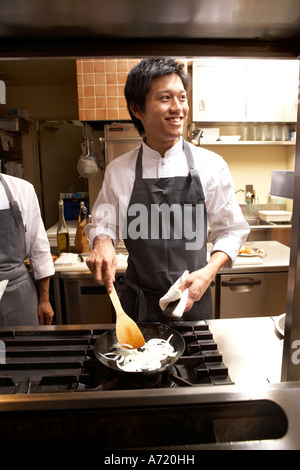 Man japanese restaurant chef cooking in the kitchen Stock Photo - Alamy