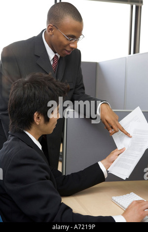 Two businessmen looking at documents Stock Photo - Alamy