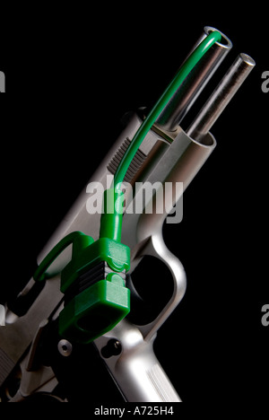 Handgun with safety lock and cable in the breech and barrel Stock Photo ...