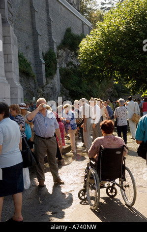 Pilgrims in Lourdes France drinking holy water Stock Photo - Alamy
