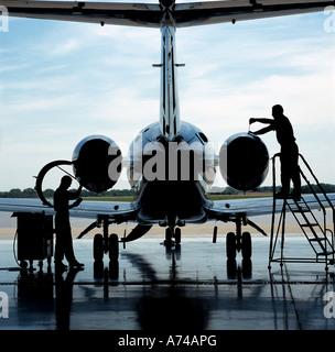 Two mechanics perform maintenance on the main rotor of a UH-60 Black ...