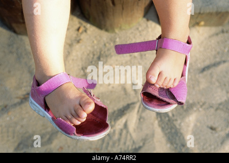 Little girl taking off her shoes Stock Photo: 97710820 - Alamy