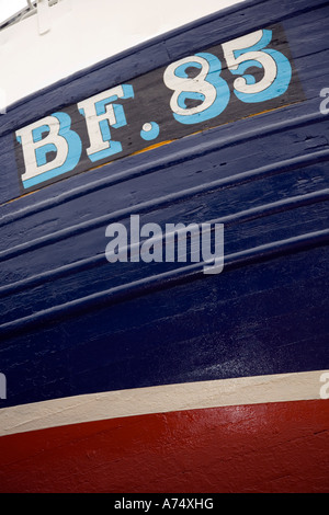 Fishermen load fishing lines into a boat at the harbour of Nuuk ...