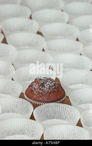 Empty cupcake cases one chocolate muffin full frame Stock Photo - Alamy