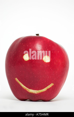 Smiley face on red aple Stock Photo - Alamy