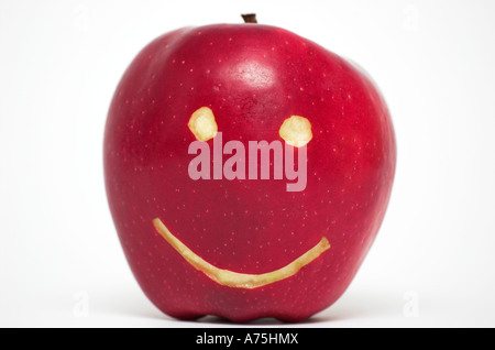 Smiley face on red aple Stock Photo - Alamy