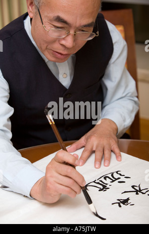 Middle-aged man practicing calligraphy Stock Photo - Alamy