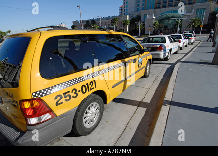 A line of taxi cabs wait to move down the line to pick up passengers ...