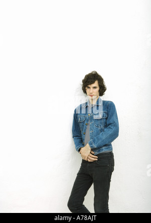 Camera headed man standing on green grass against modern cityscape ...