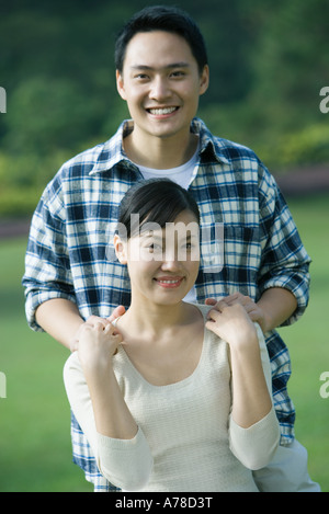a woman's hand holds a green button to mark the date on a white ...