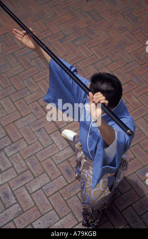 Man performing traditional dance with Japanese music instrument, Sasara ...
