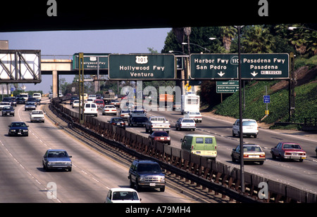 some cars and a motorcycle driving on a highway with several lanes in ...