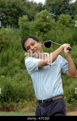 Asian man playing golf MR Robin Nelson Stock Photo - Alamy