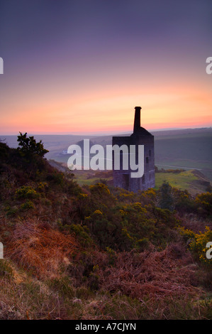 Derelict mine engine Wheal Betsy near Tavistock with the orange glow of ...