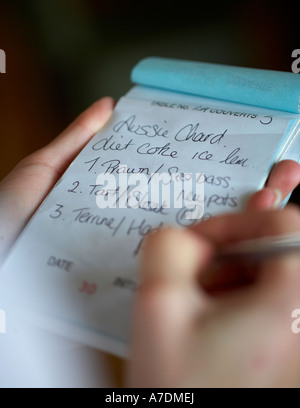 waiter writing order on a pad in a restaurant Stock Photo - Alamy