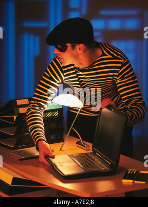 Burglar in traditional costume. Burglar with swag bag and keyboard ...