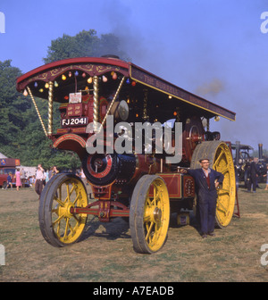 Showmans fairground steam traction engine dusk with lights men in ...