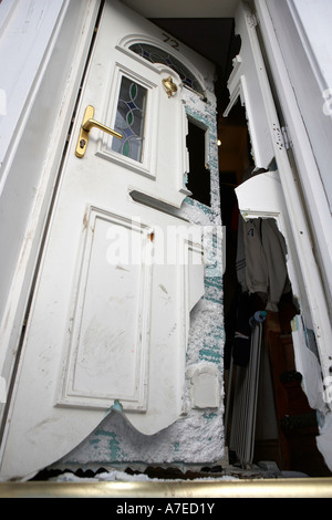 Police break down a front door during a raid on suspected drugs Stock ...
