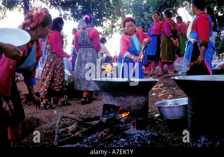 Traditionally dressed Lisu women preparing food at a gathering in ...
