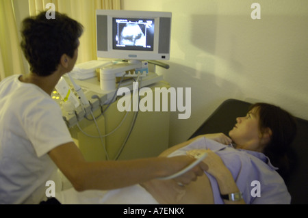 pregnant woman female montior screen maternity ante natal clinic ...