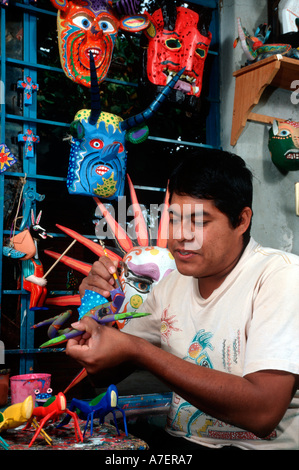 Mexico, Oaxaca, Tilcajete, Painting alibrijes (hand-painted wooden ...