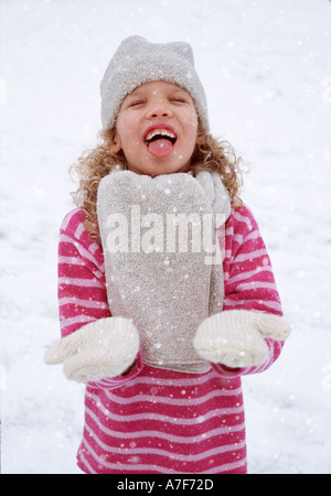 Girl eating snowflakes with her tongue Stock Photo - Alamy