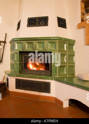 tiled stove burning with firewood in typical German way Stock Photo - Alamy