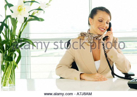 Switchboard operator sitting at telephone switchboard and talking Stock ...
